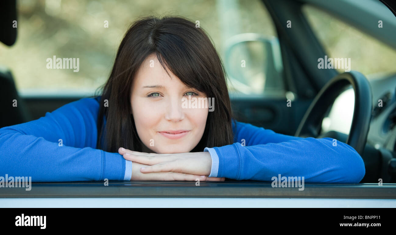 Cute teen girl smiling at the camera sitting in her car Stock Photo - Alamy