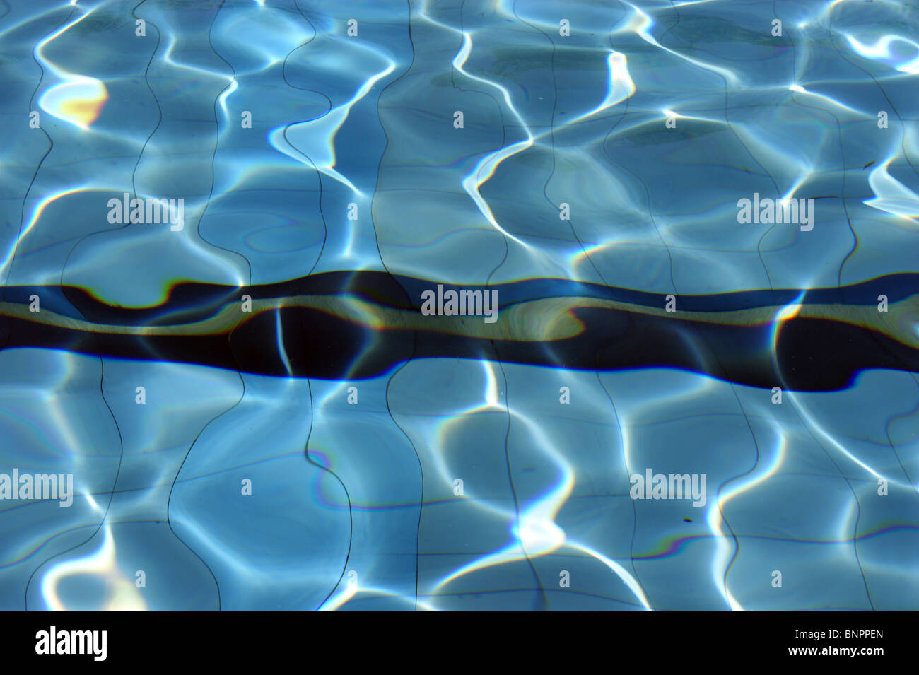 SUN REFLECTING ON THE WATER ON AN OUTDOOR SWIMMING POOL IN SPAIN Stock ...