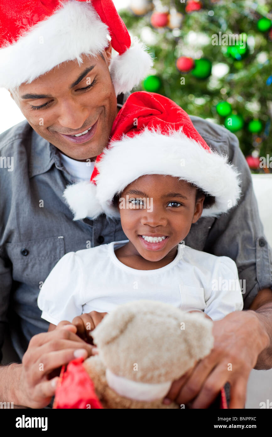 Happy little girl playing with a Christmas gift with her father Stock ...