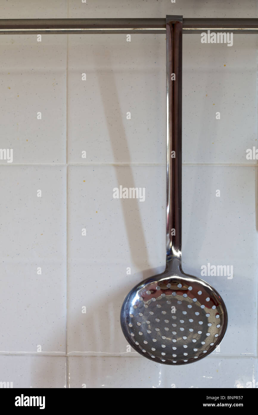 Kitchen Utensils on white tile Stock Photo - Alamy