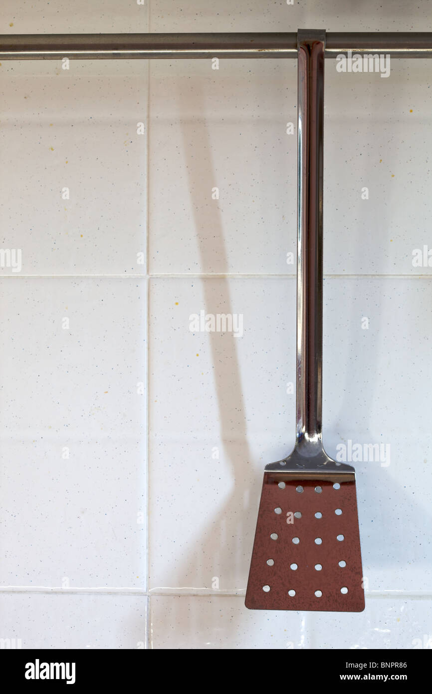 Kitchen Utensils on white tile Stock Photo - Alamy