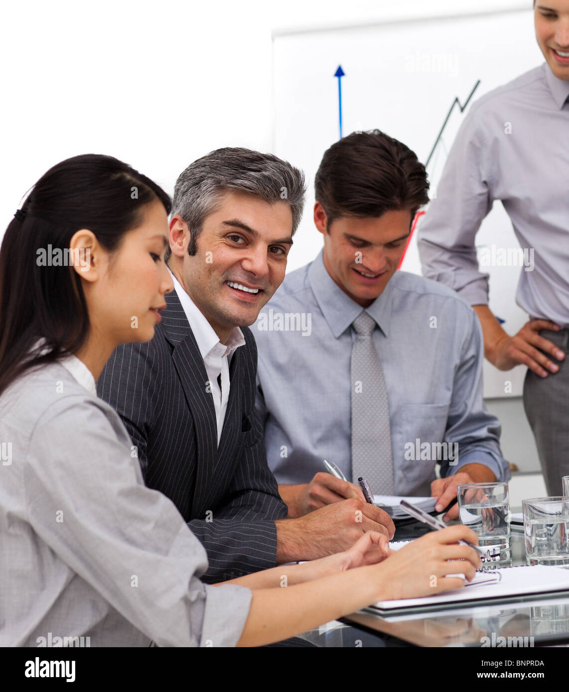 Smiling mature manager in a meeting with his team Stock Photo - Alamy