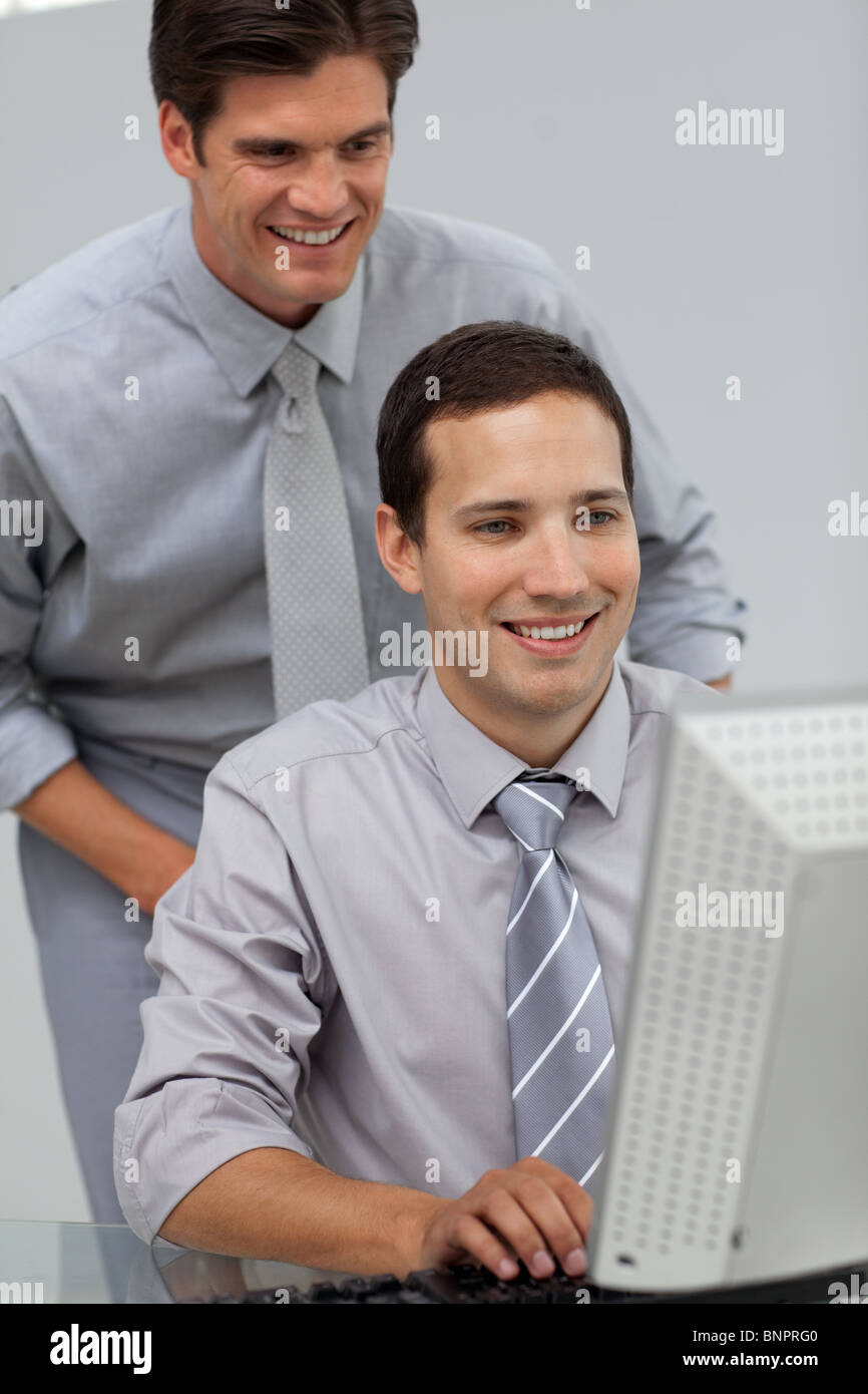 Self-assured businessman helping his colleague Stock Photo - Alamy