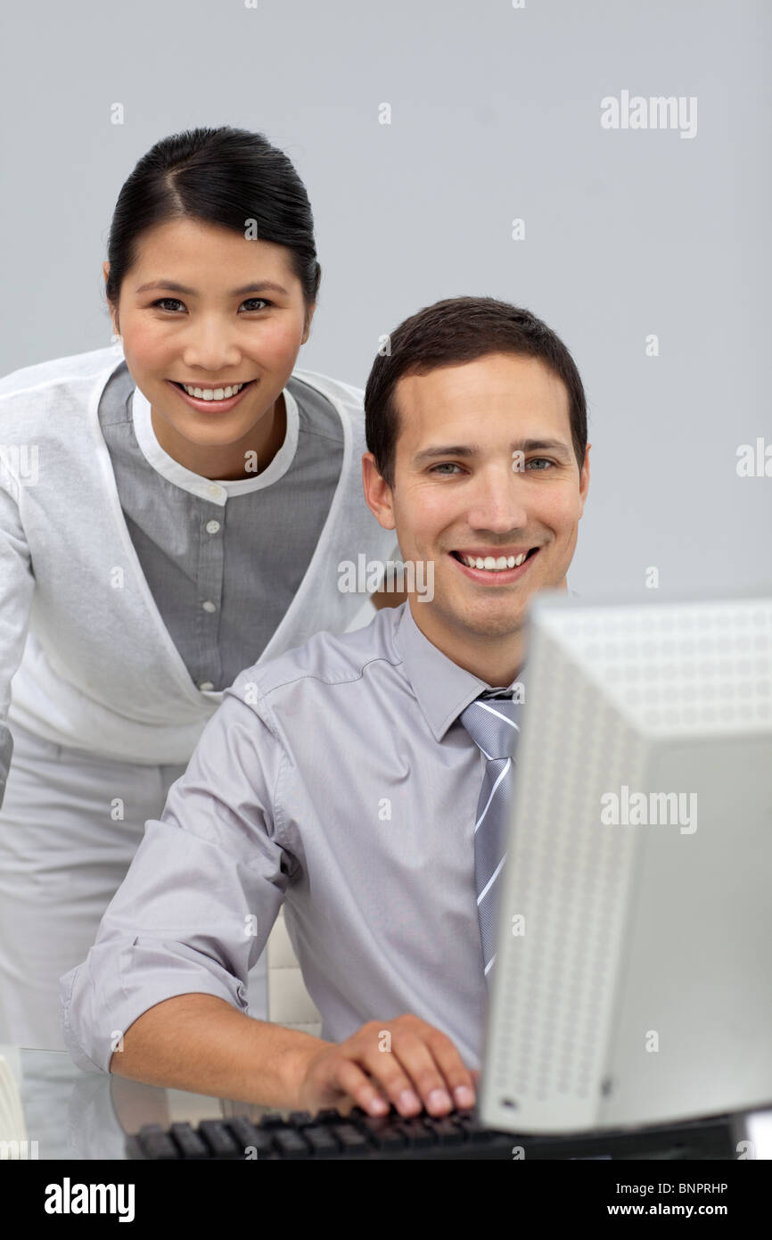 Assertive businesswoman helping her colleague Stock Photo - Alamy