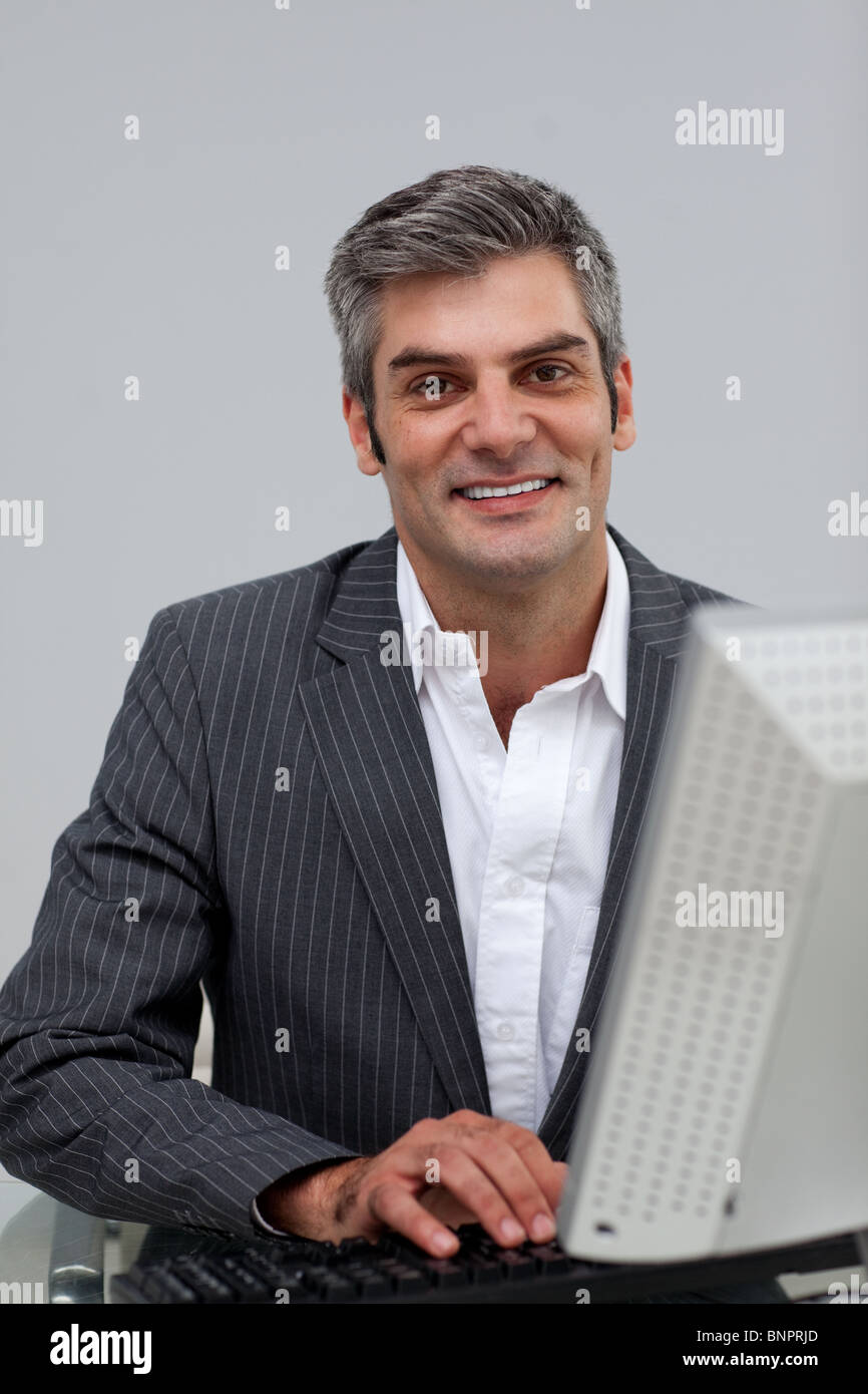Self-assured male executive working at a computer Stock Photo - Alamy