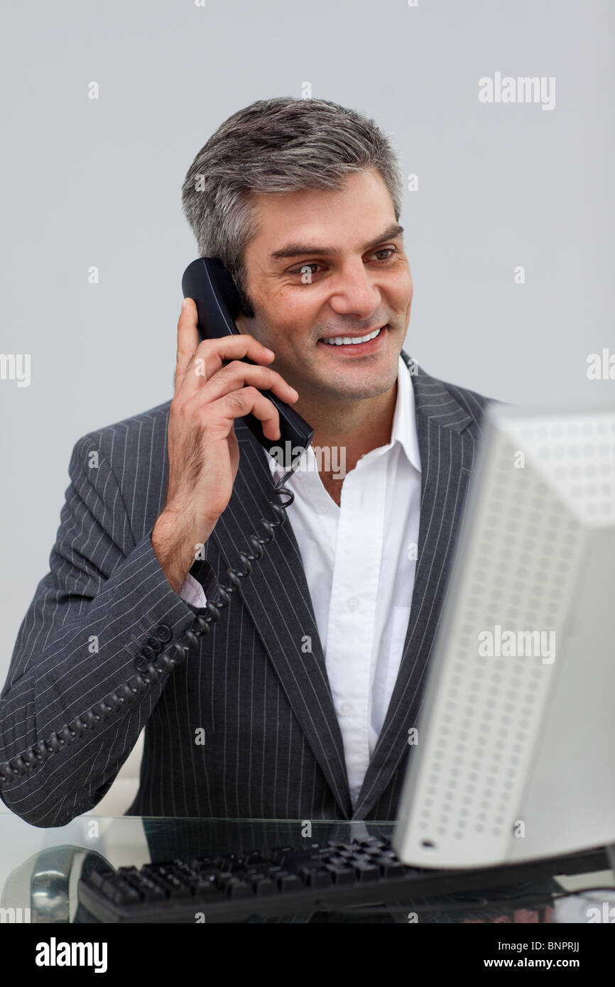 Positive male executive talking on phone Stock Photo - Alamy