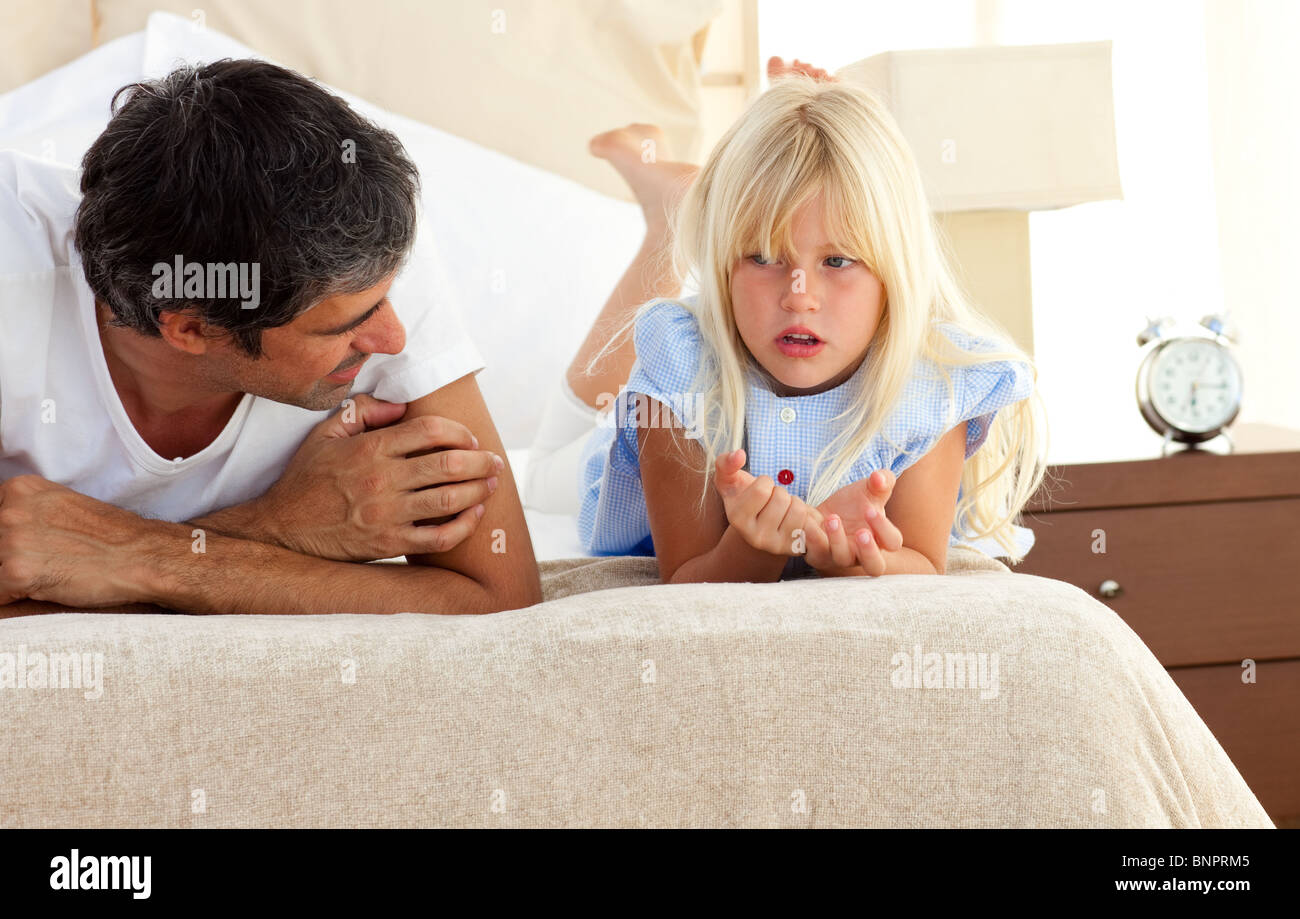 Little girl talking seriously with her father Stock Photo - Alamy