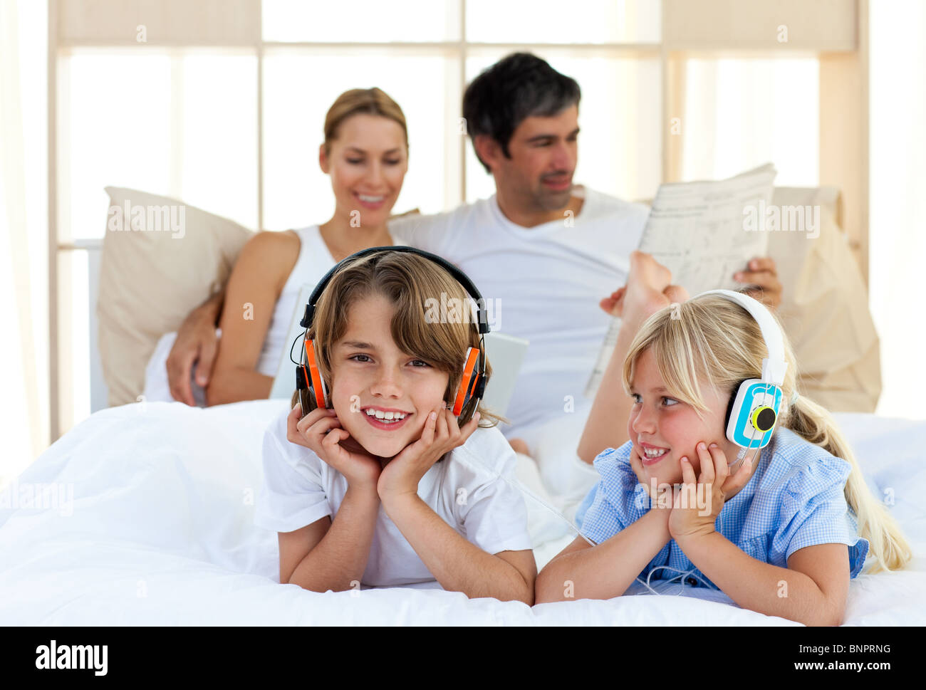 Brother and sister listening music with headphones Stock Photo - Alamy