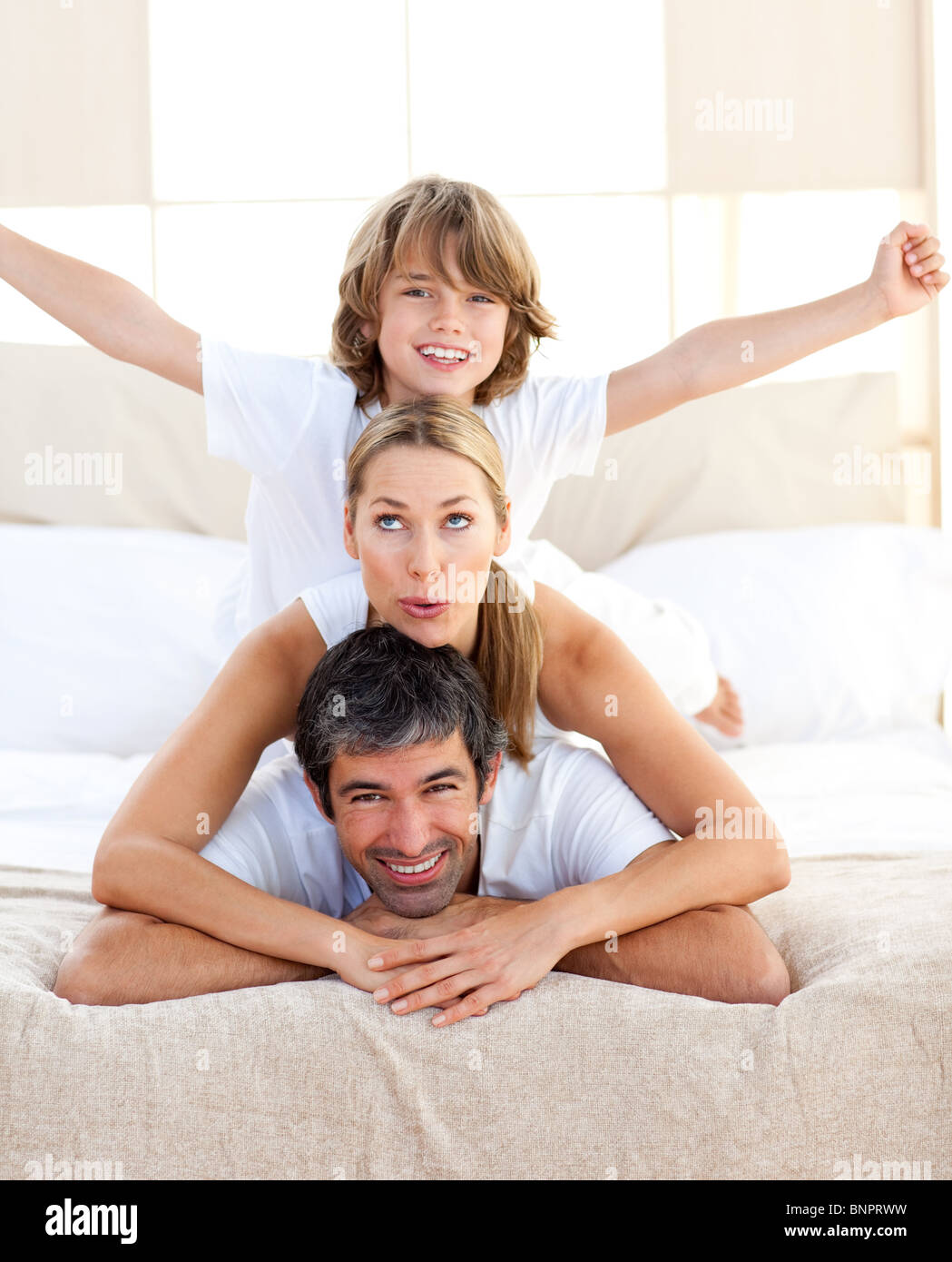 Cute child and his parents having fun Stock Photo - Alamy