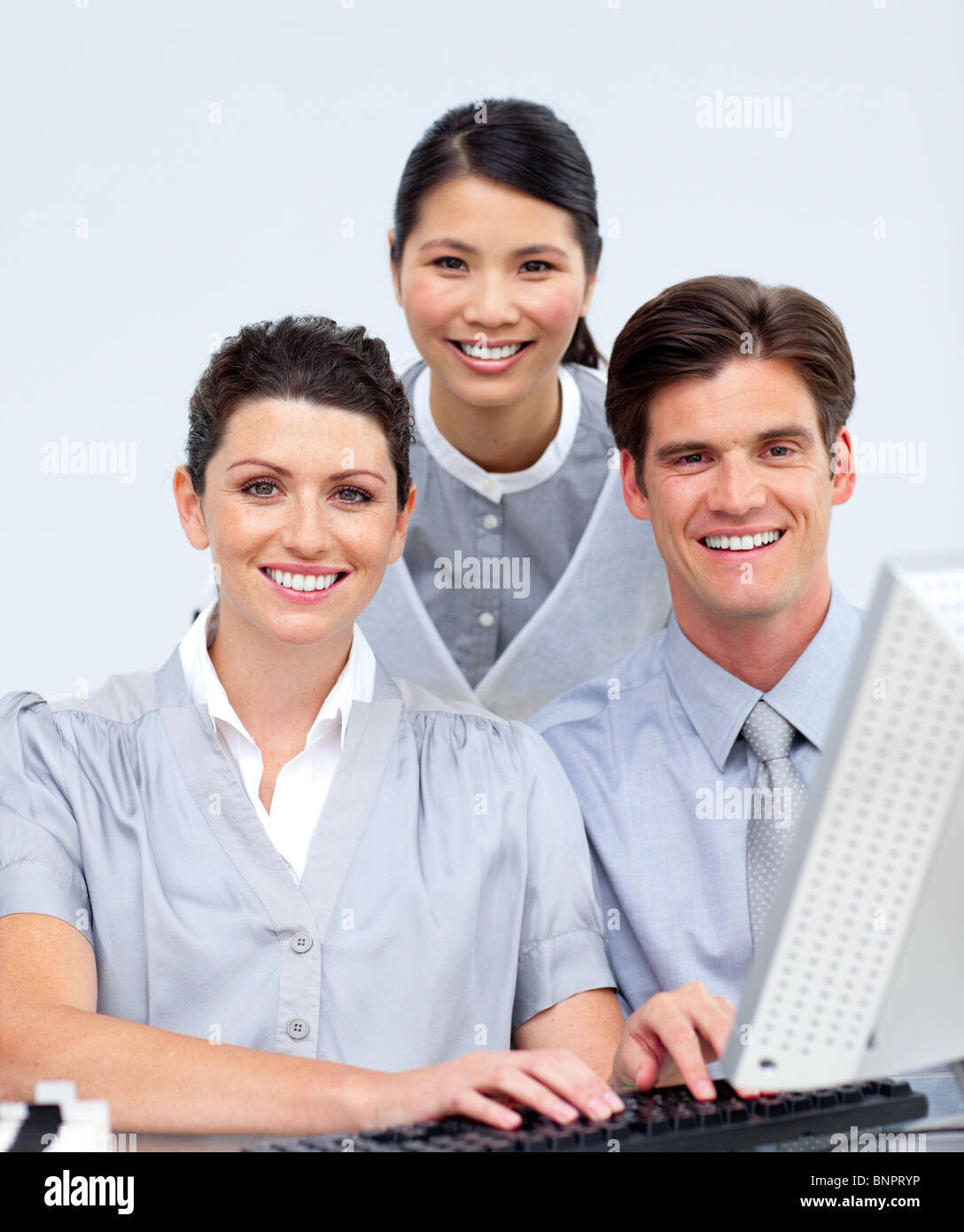 Smiling business people working at a computer Stock Photo - Alamy