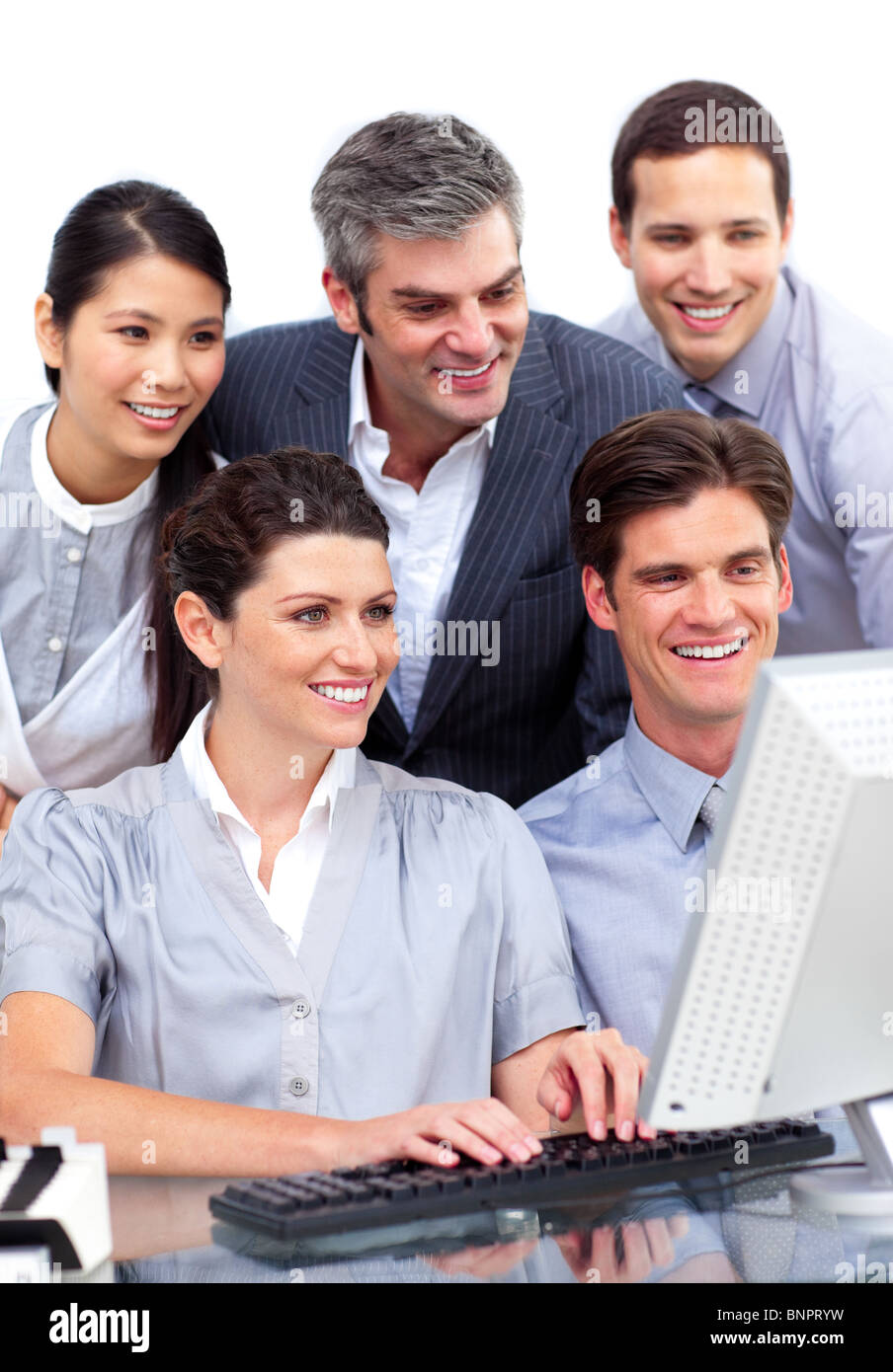 Happy business people working at a computer Stock Photo - Alamy