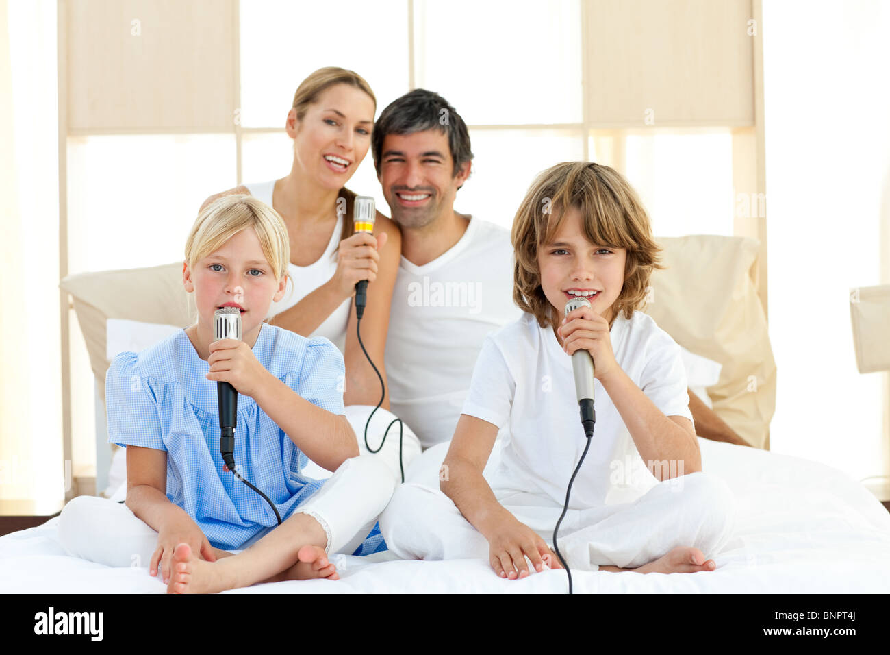Jolly family singing together Stock Photo - Alamy