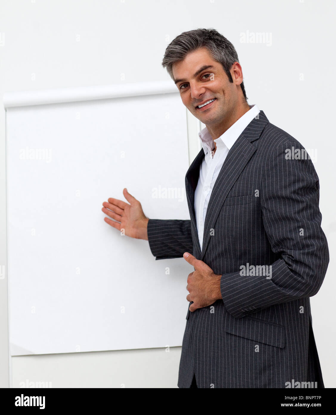 Self-assured male executive pointing at a board Stock Photo - Alamy