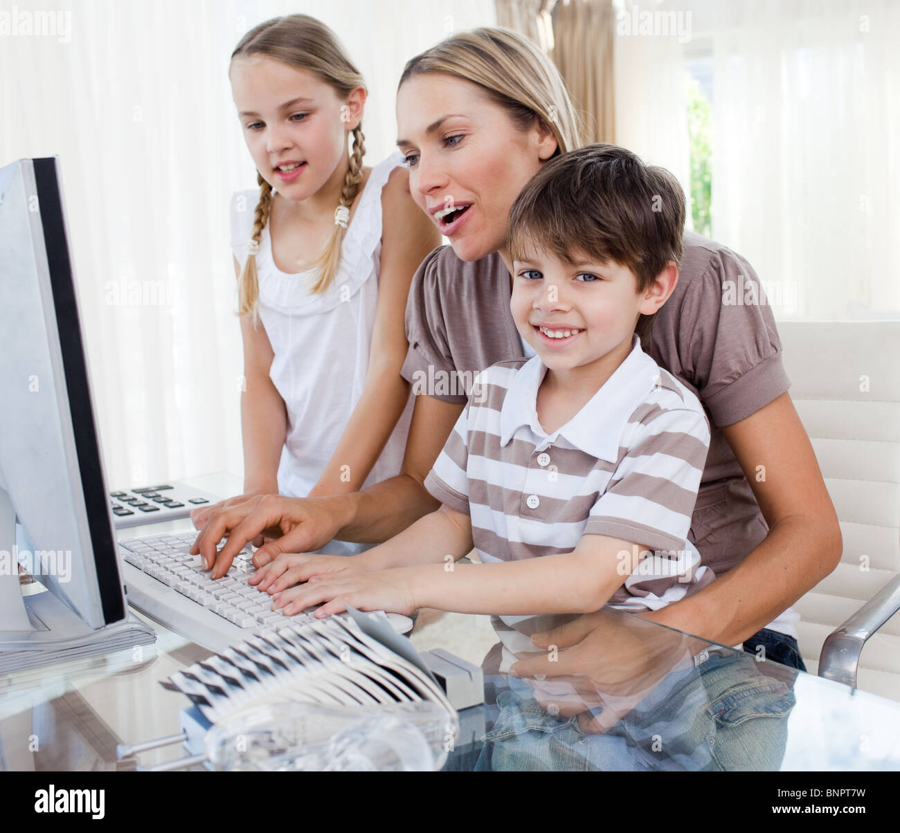 Smiling little boy at a computer Stock Photo - Alamy