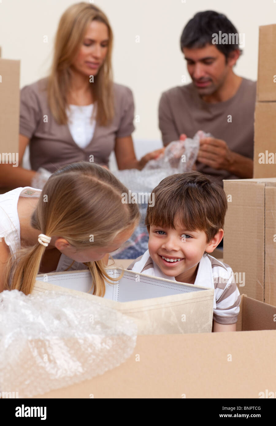 Smiling siblings having fun during house moving Stock Photo - Alamy