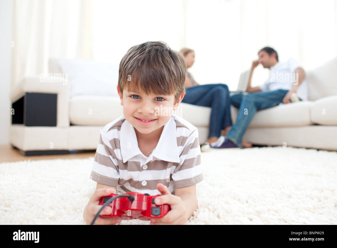 Adorable little boy playing video games Stock Photo - Alamy