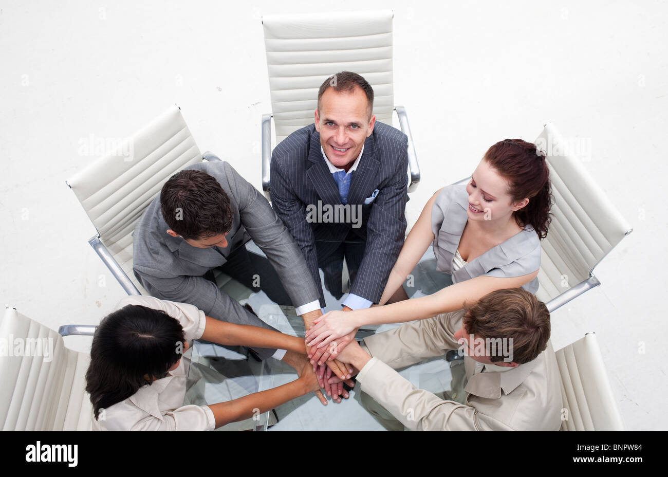 Smiling manager holding his colleagues' hands Stock Photo - Alamy