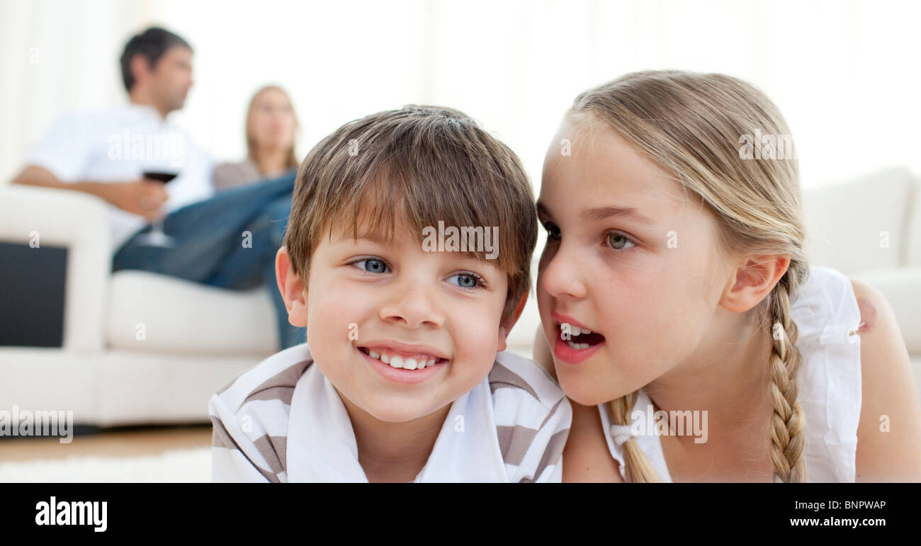 Little girl telling a secret to her brother Stock Photo - Alamy
