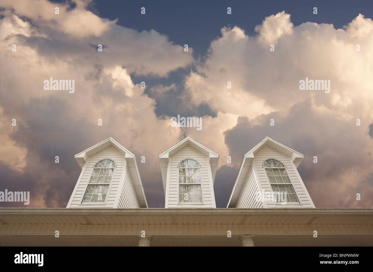 House Roof and Windows Against a Cloudy Sky Stock Photo - Alamy