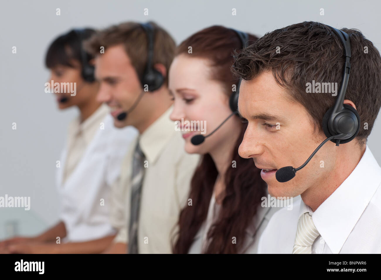 Attractive man with a headset on working in a call center Stock Photo ...