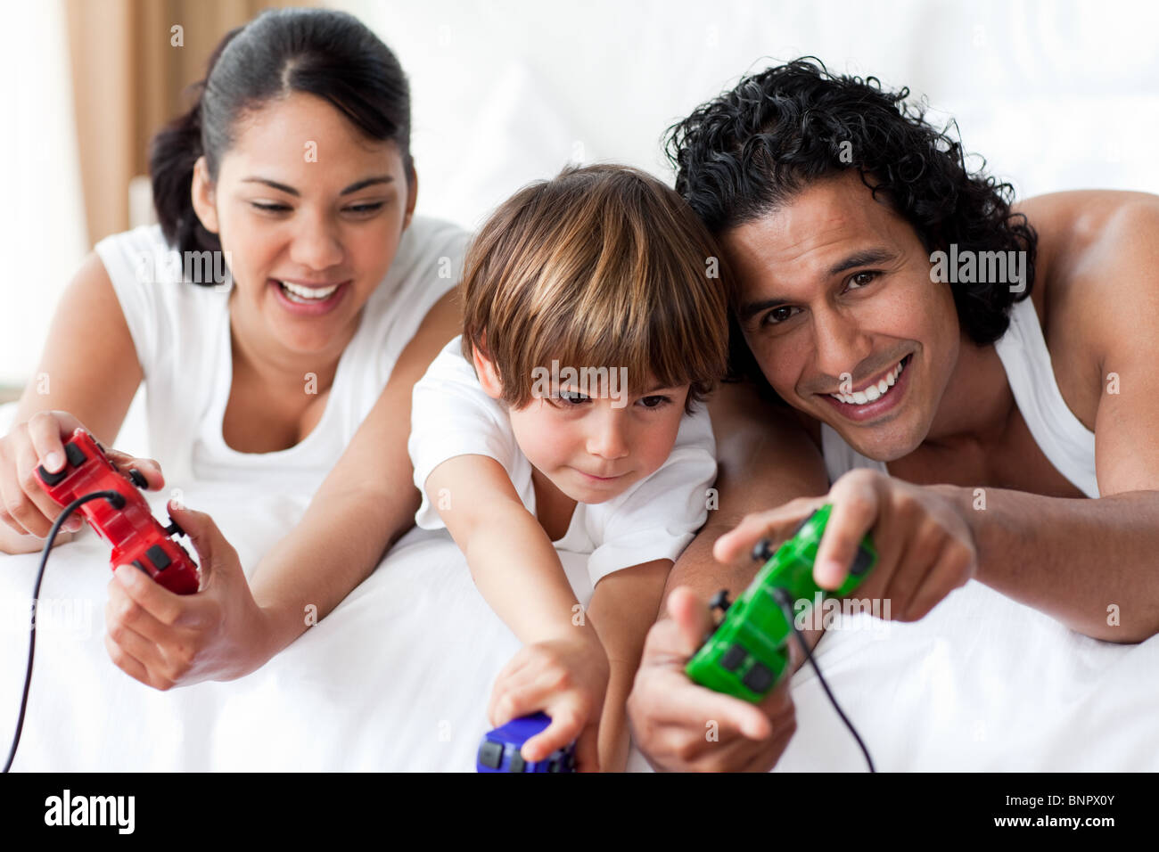 Portrait of smiling parents playing video games with their son Stock ...