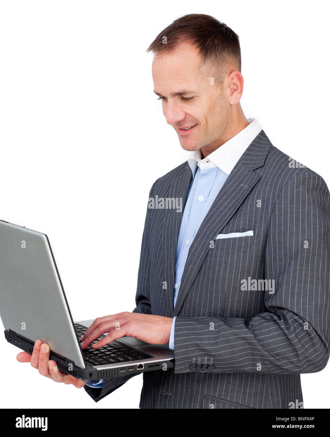 Smiling businessman using a laptop Stock Photo - Alamy