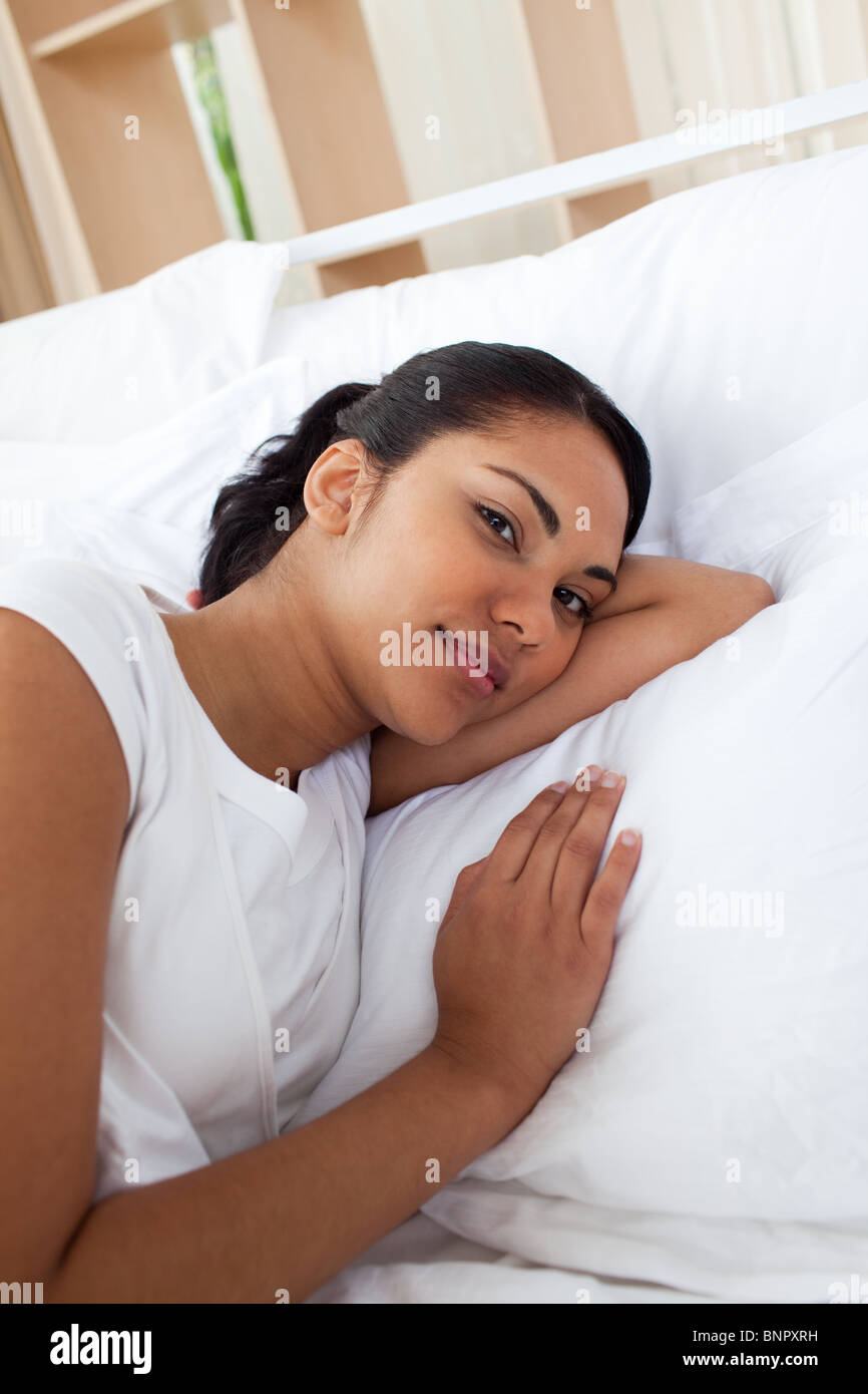 Smiling woman lying on the bed Stock Photo - Alamy