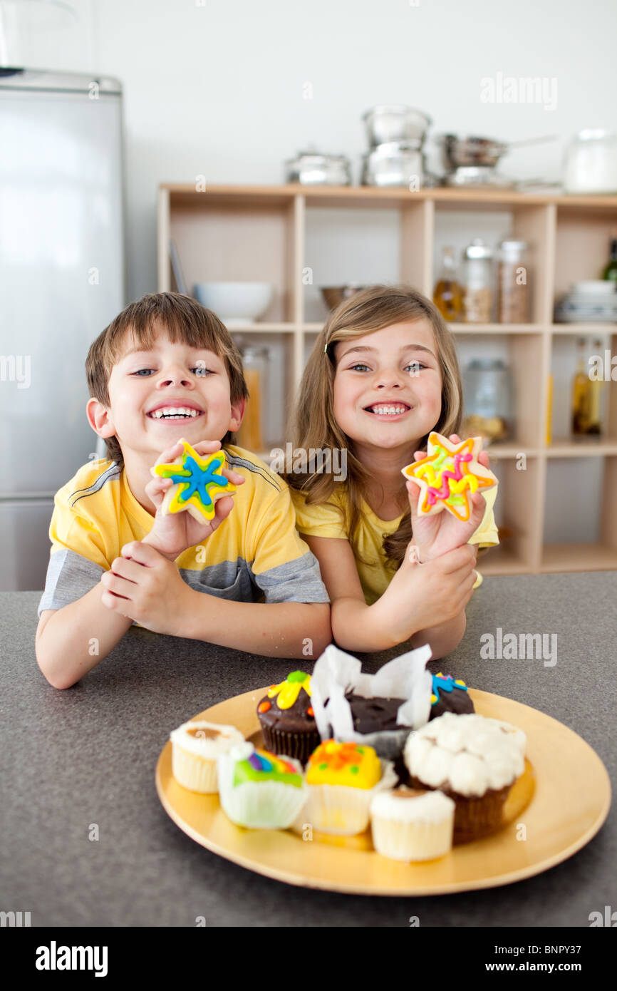 Cute siblings showing their cookies Stock Photo - Alamy