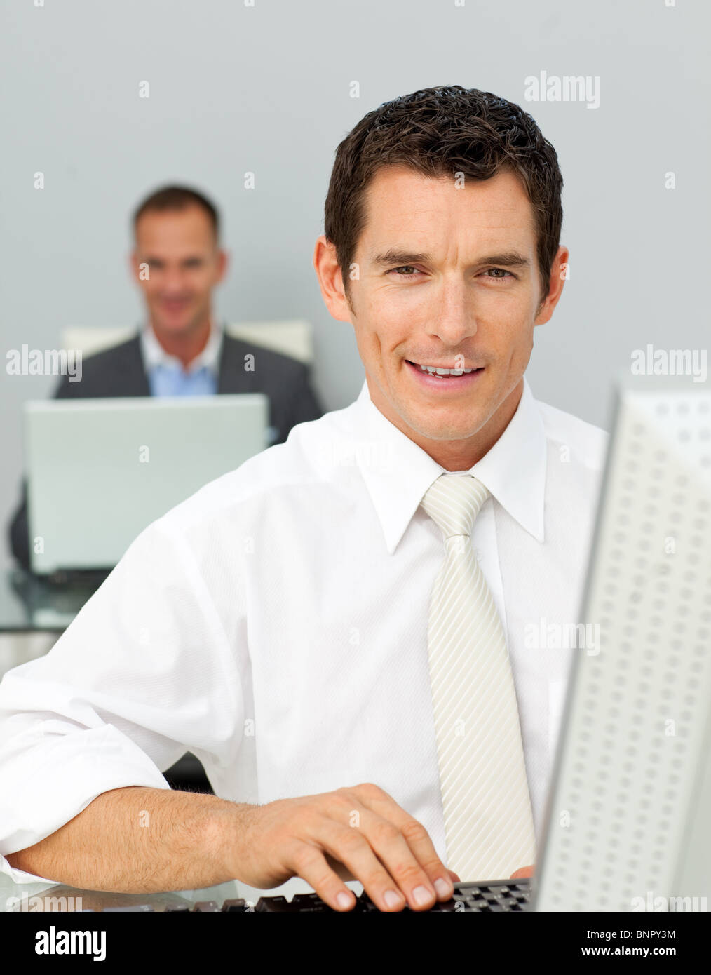 Confident businessman working at his computer Stock Photo - Alamy