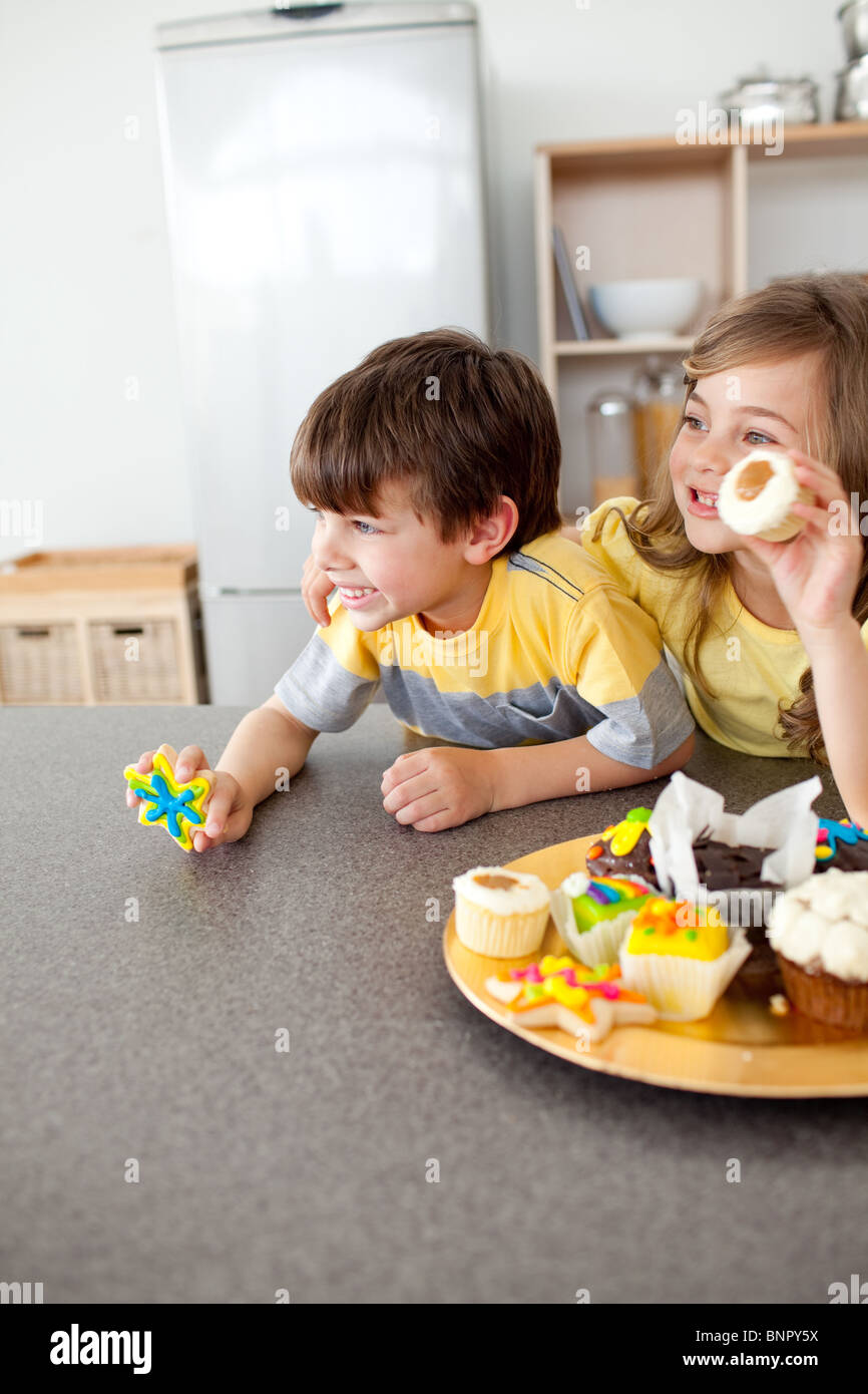 Smiling children showing their cookies Stock Photo - Alamy