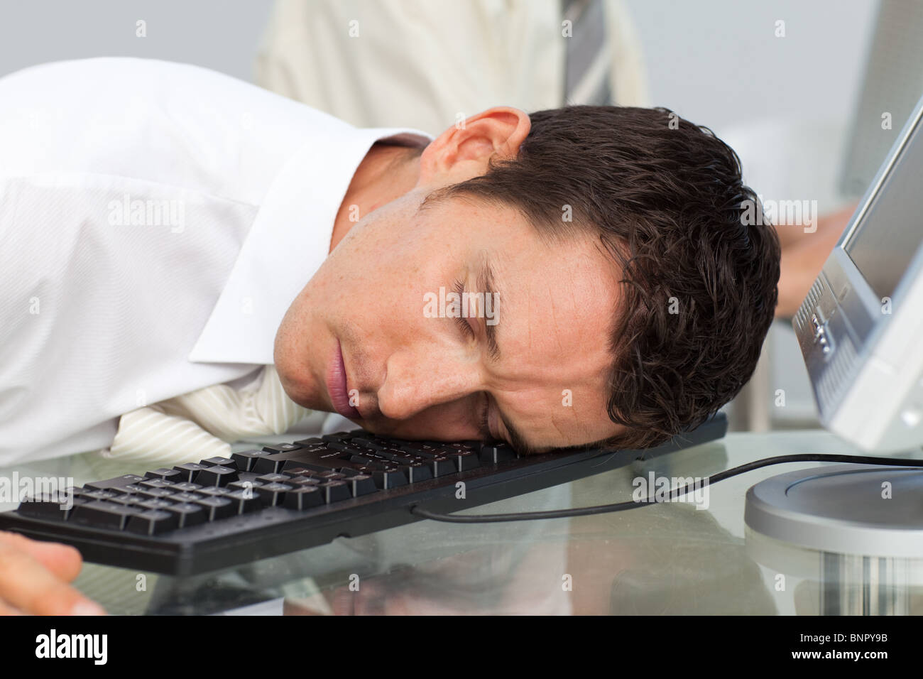 Businessman sleeping on the keyboard in the office Stock Photo - Alamy