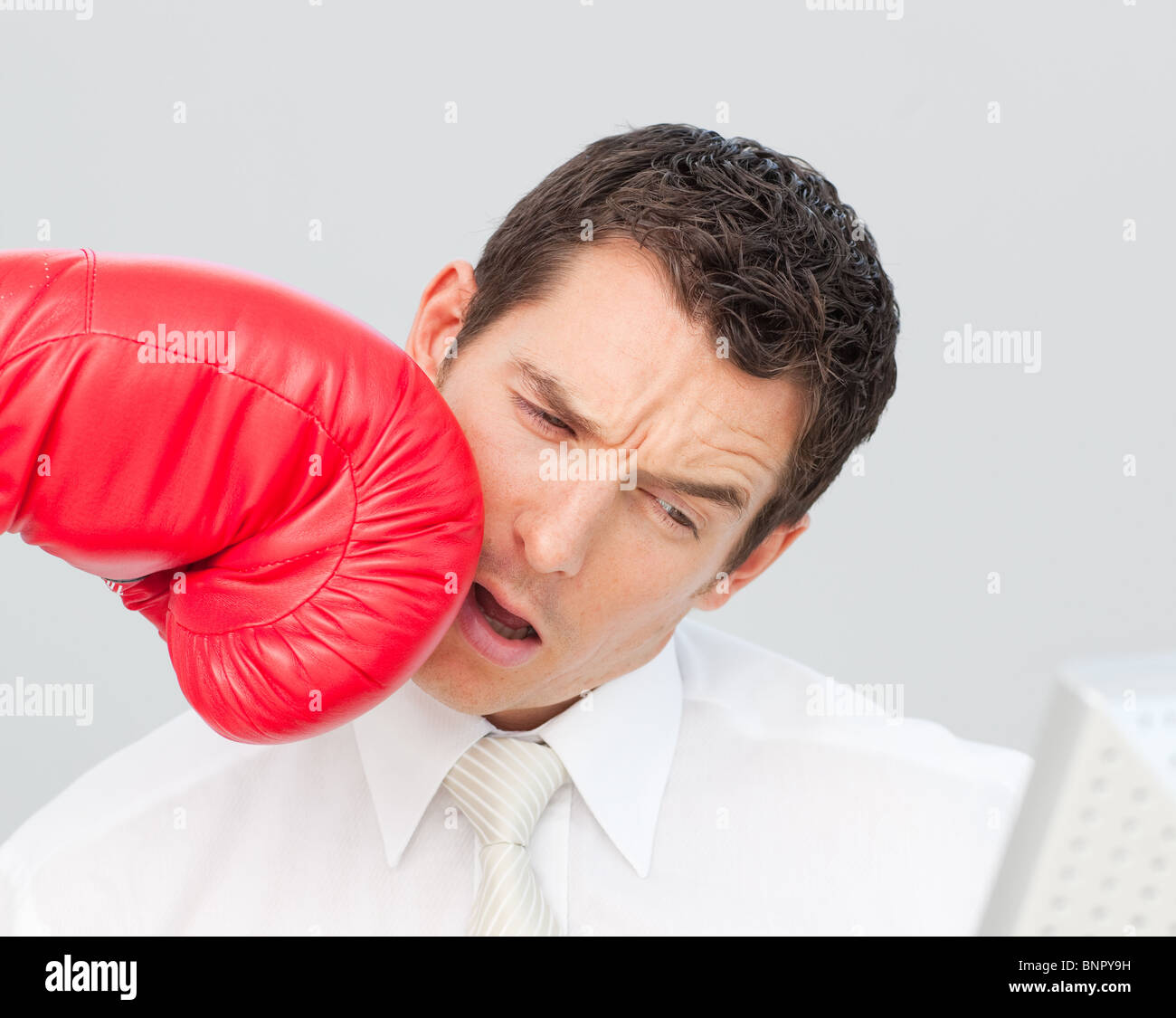 Boxing a businessman in his face Stock Photo - Alamy