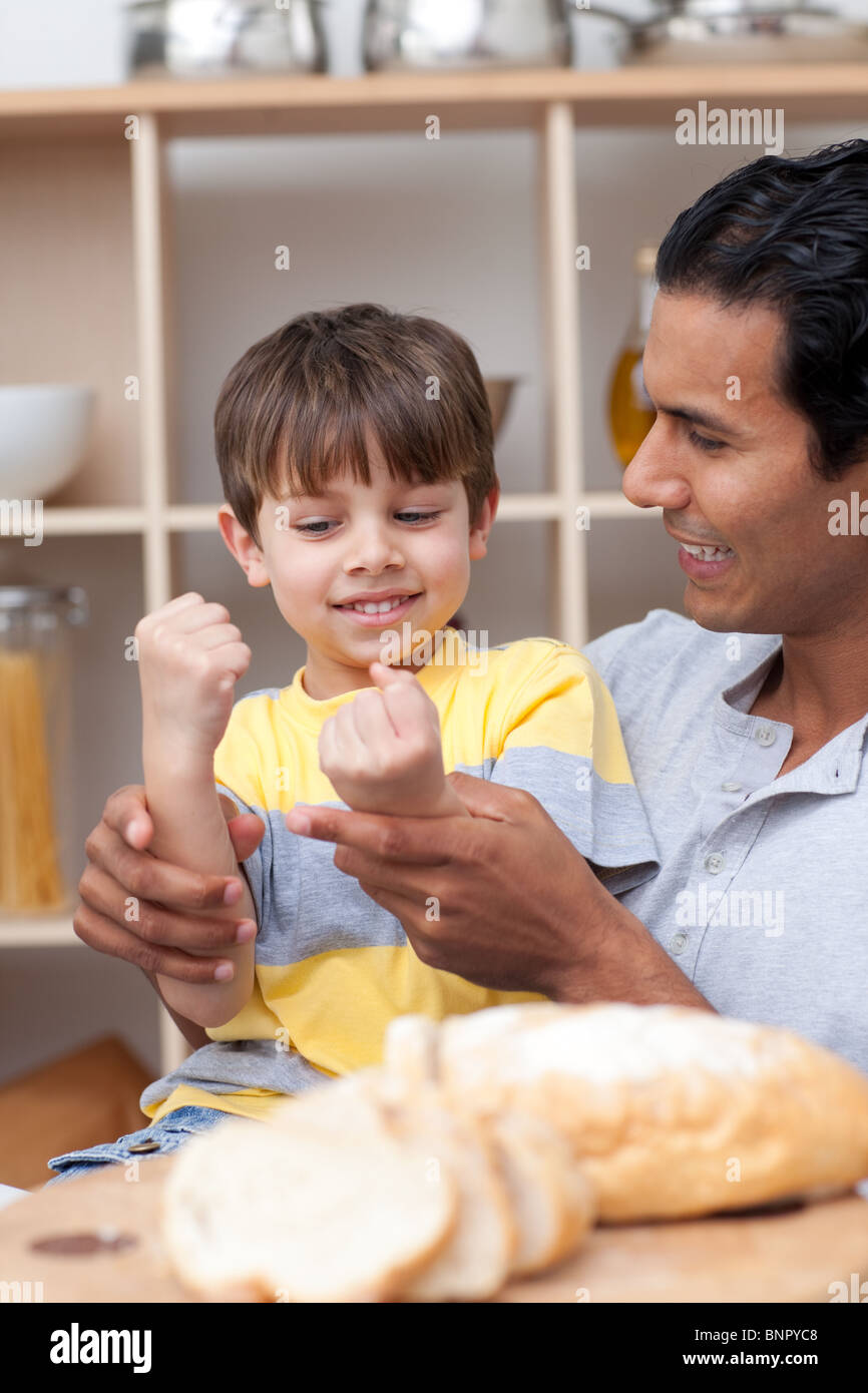 Father and son cutting bread Stock Photo - Alamy