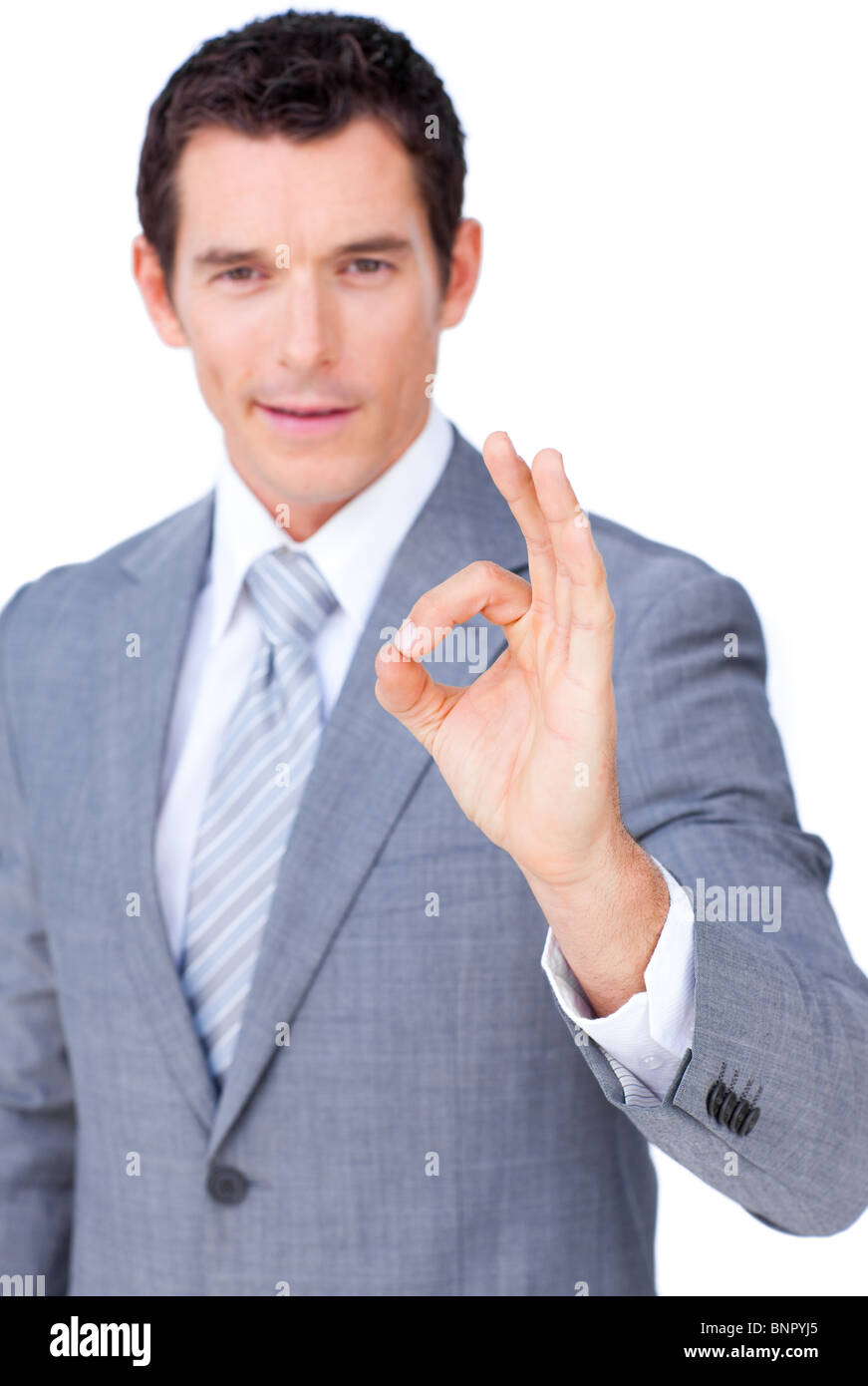 Charismatic businessman showing OK sign Stock Photo - Alamy