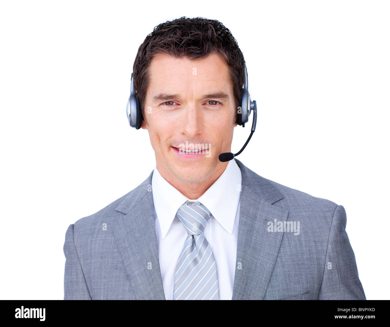 Self-assured businessman using headset Stock Photo - Alamy