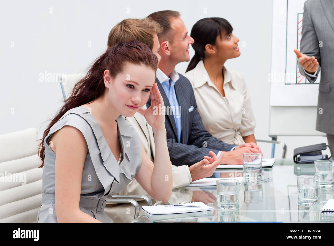 Businesswoman getting tired in a meeting Stock Photo - Alamy