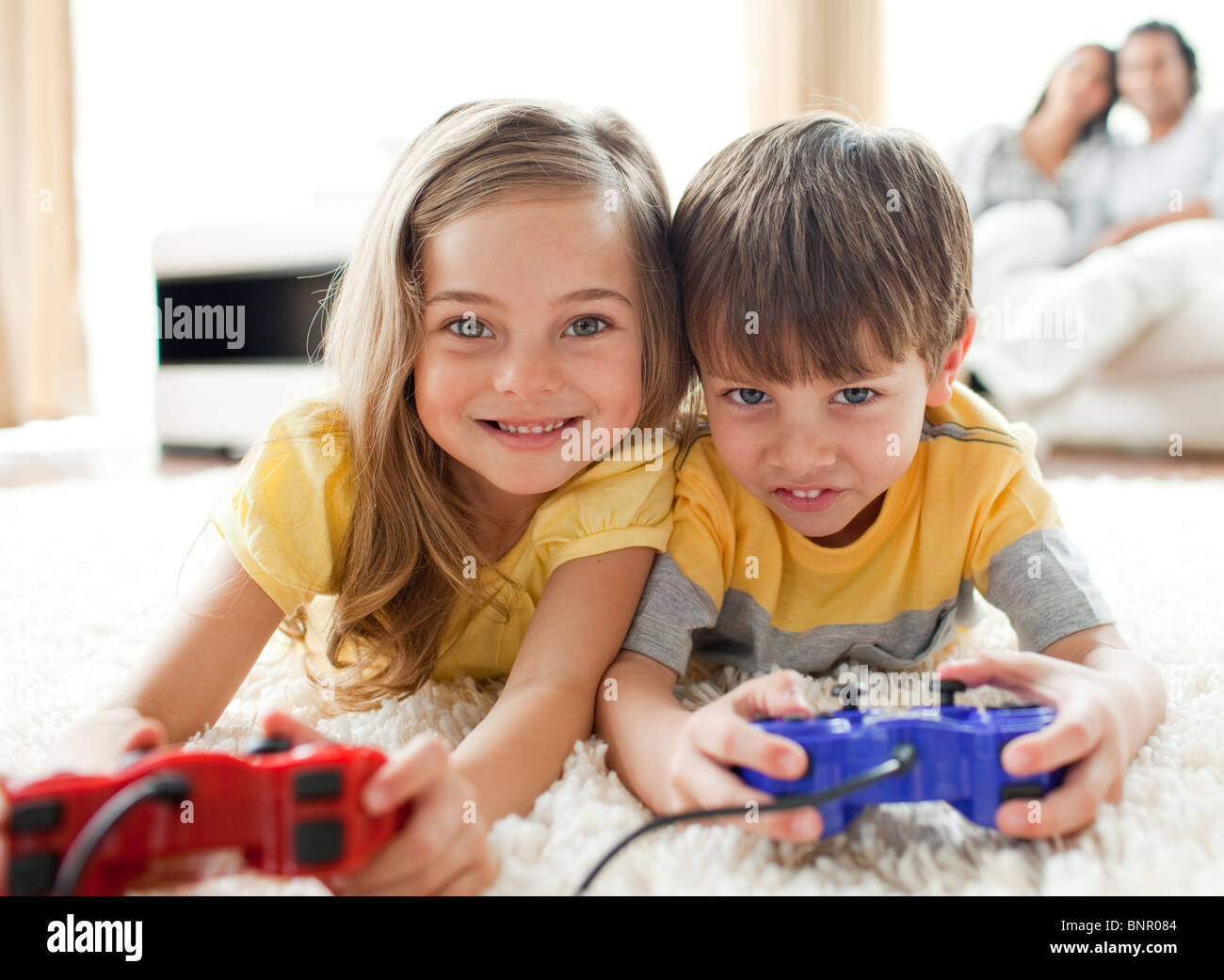 Adorable siblings playing video game Stock Photo - Alamy