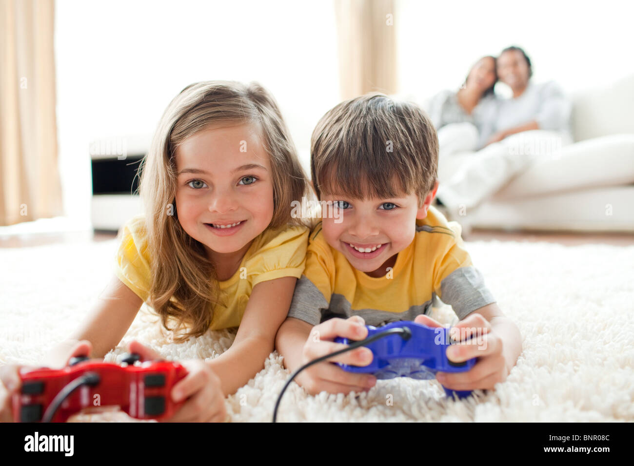 Loving siblings playing video game Stock Photo - Alamy