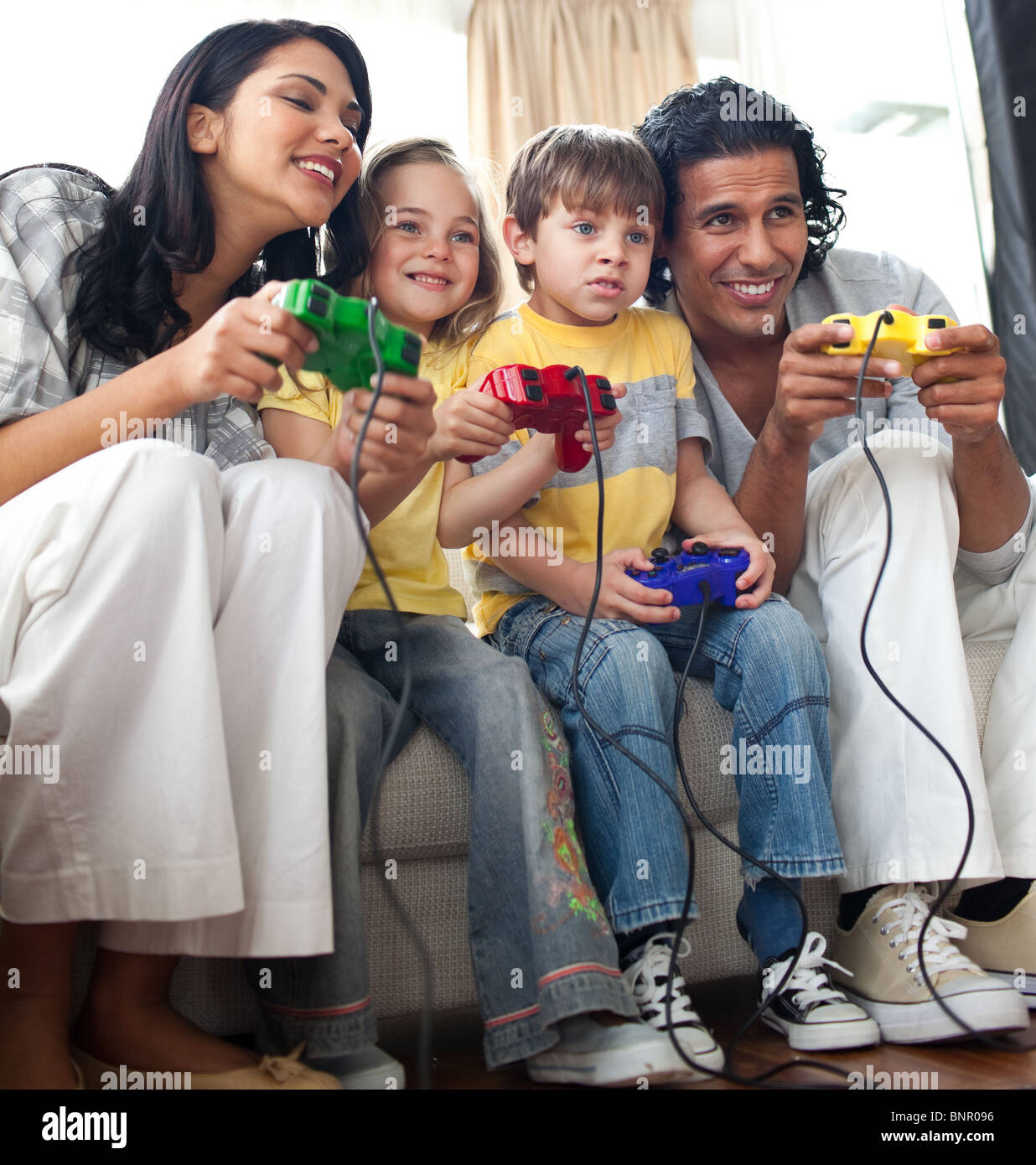 Lively family playing video game Stock Photo - Alamy