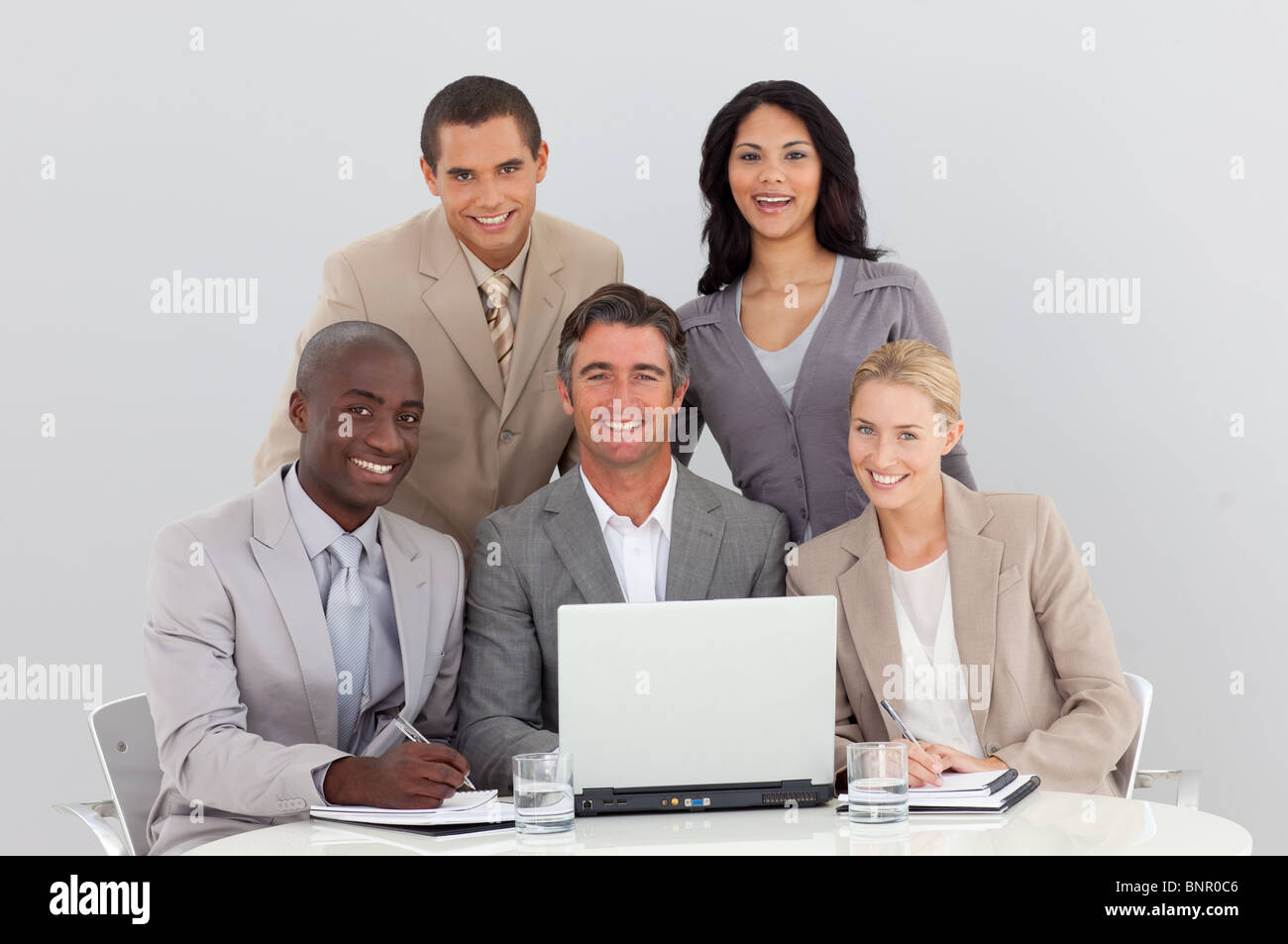 Happy business team working in office together Stock Photo - Alamy