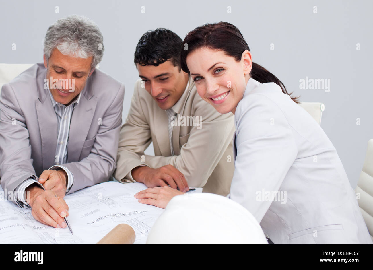 Portrait of a female engineer studying plans with her colleagues Stock ...