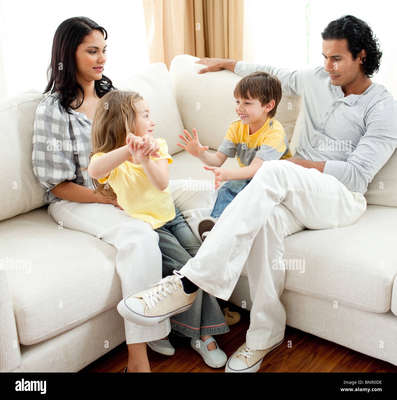 Lively family having fun in the living room Stock Photo - Alamy
