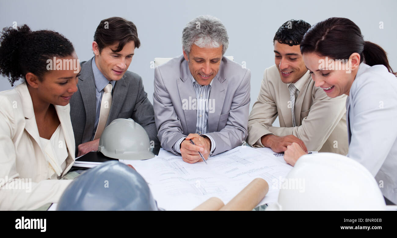 Engineers in a meeting studying plans Stock Photo - Alamy