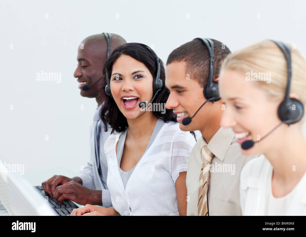 Laughing businesswoman and her team working in a call center Stock ...