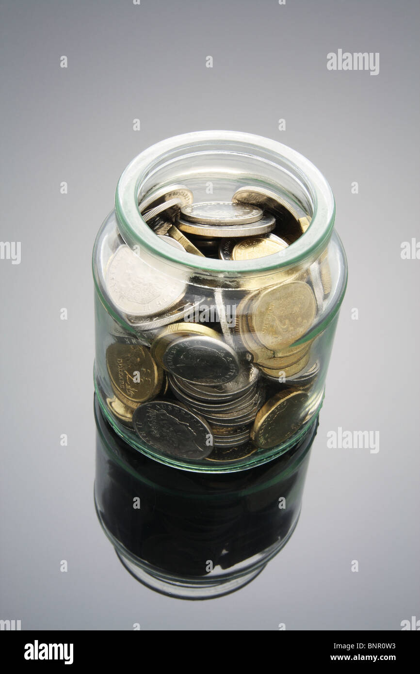 Coins in Glass Jar Stock Photo - Alamy