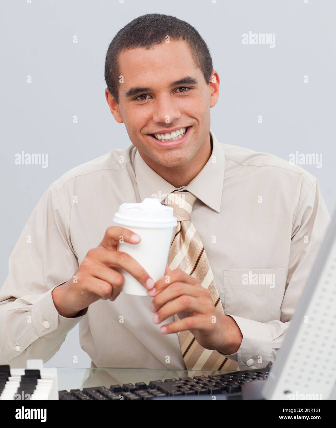 Businessman drinking coffee in the office Stock Photo - Alamy