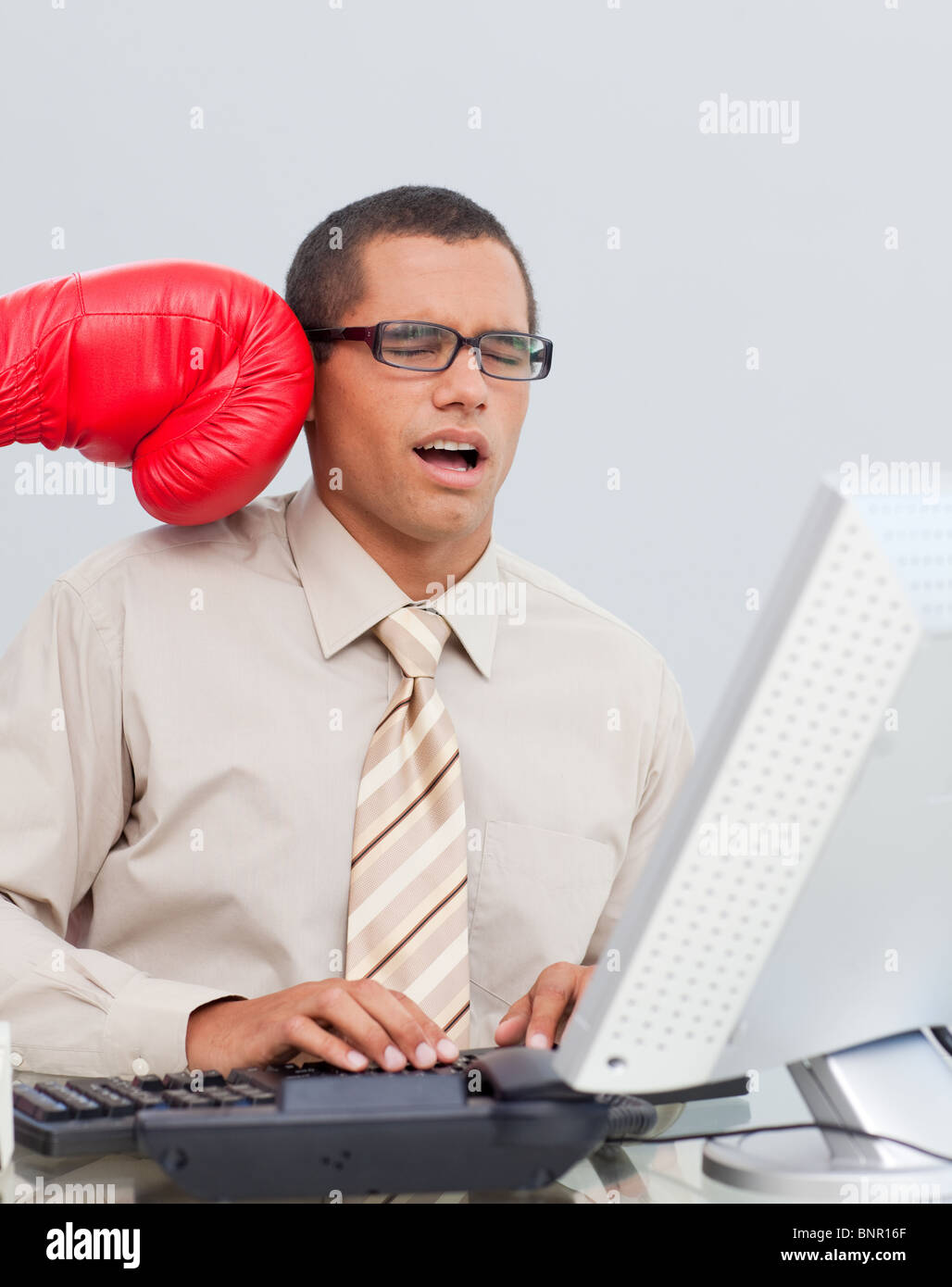 Young businessman being boxed in the office Stock Photo - Alamy