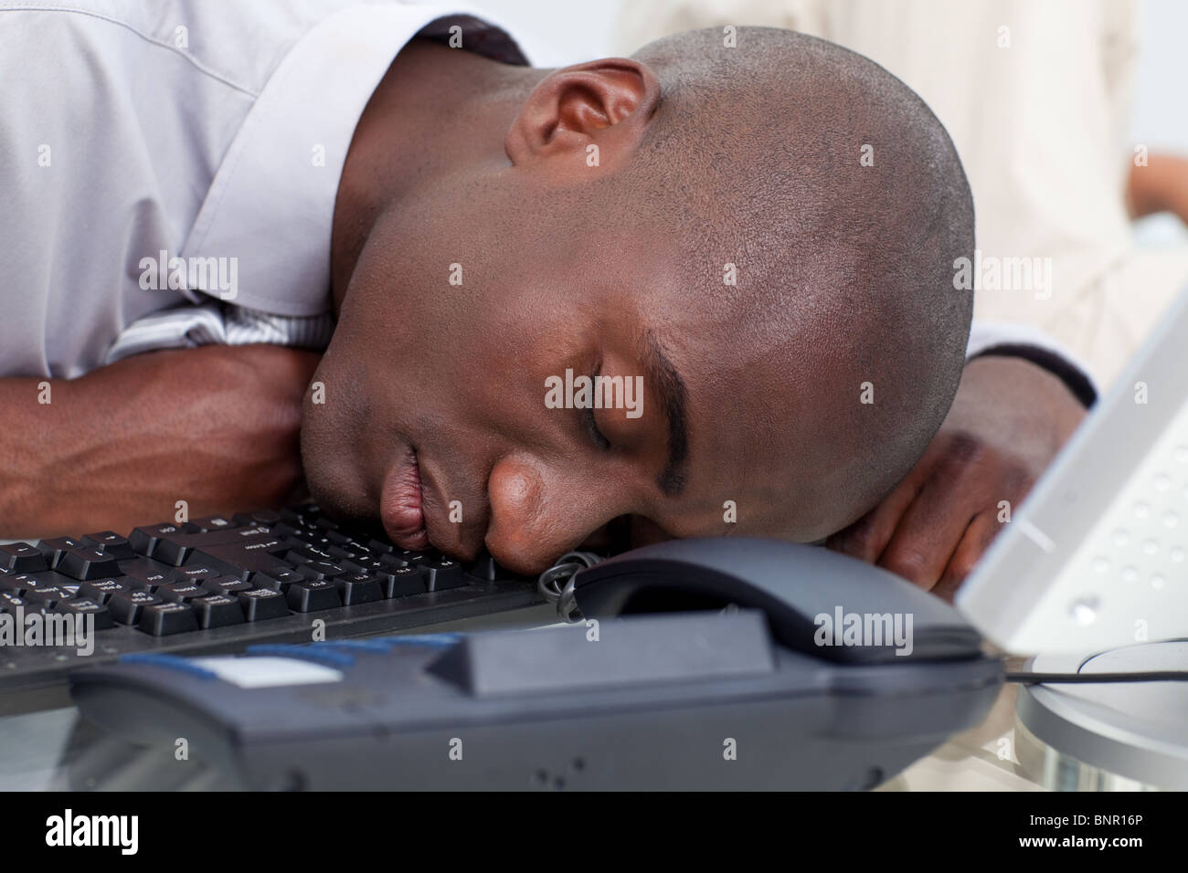 Businessman sleeping on the keyboard Stock Photo - Alamy