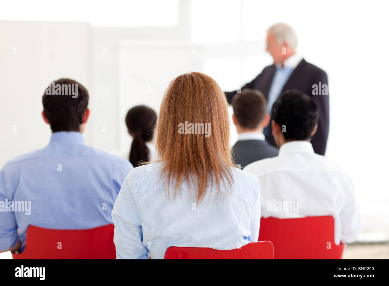 Senior businessman giving presentation team hi-res stock photography ...
