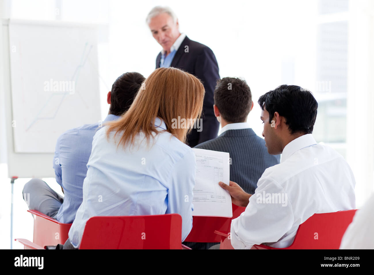 Two colleagues discussing together at a seminar Stock Photo - Alamy